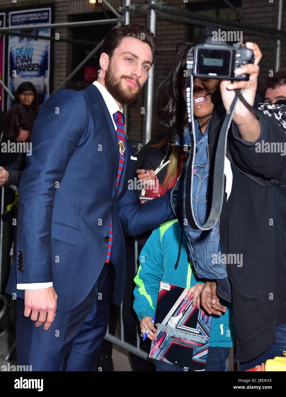 Aaron Taylor-Johnson poses for selfies and signs autographs outside ...