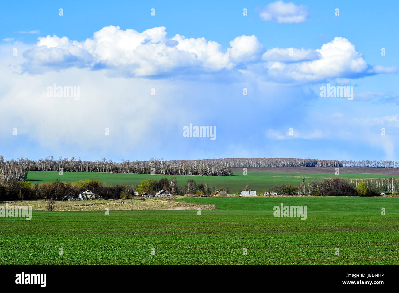 Rural landscape with a green field, clouds and farm Stock Photo - Alamy
