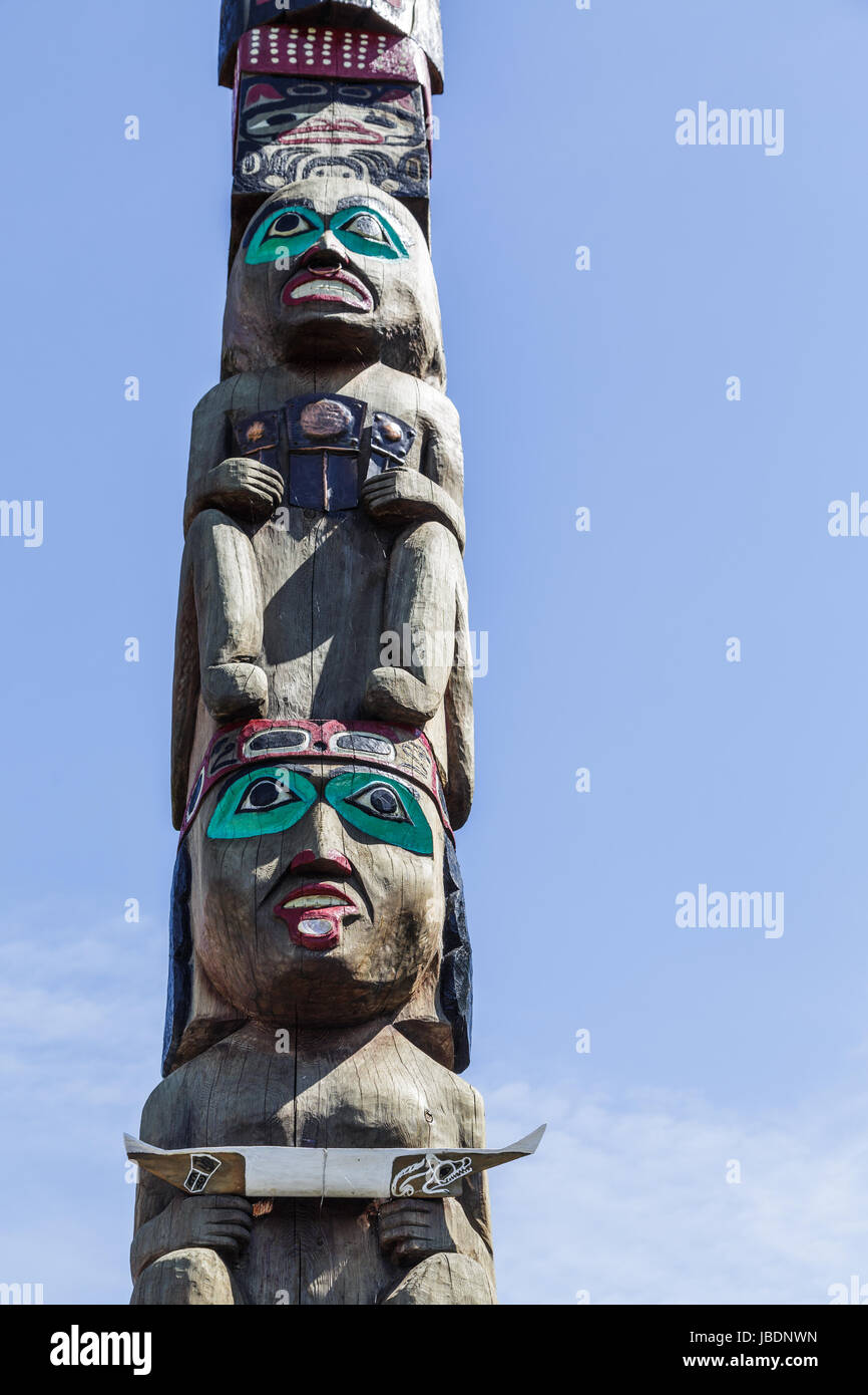 Totems with Green Eyes on Blue Sky Stock Photo - Alamy