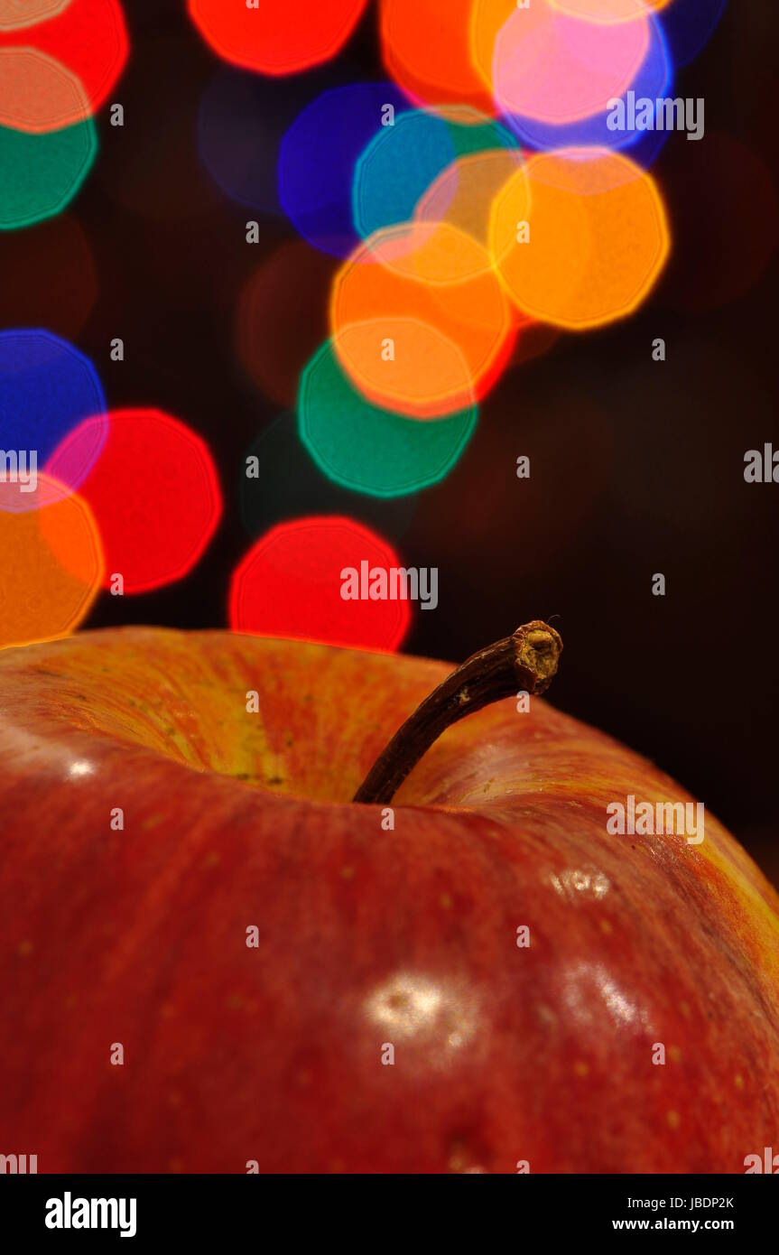 Apple with colorful lights in the background Stock Photo - Alamy