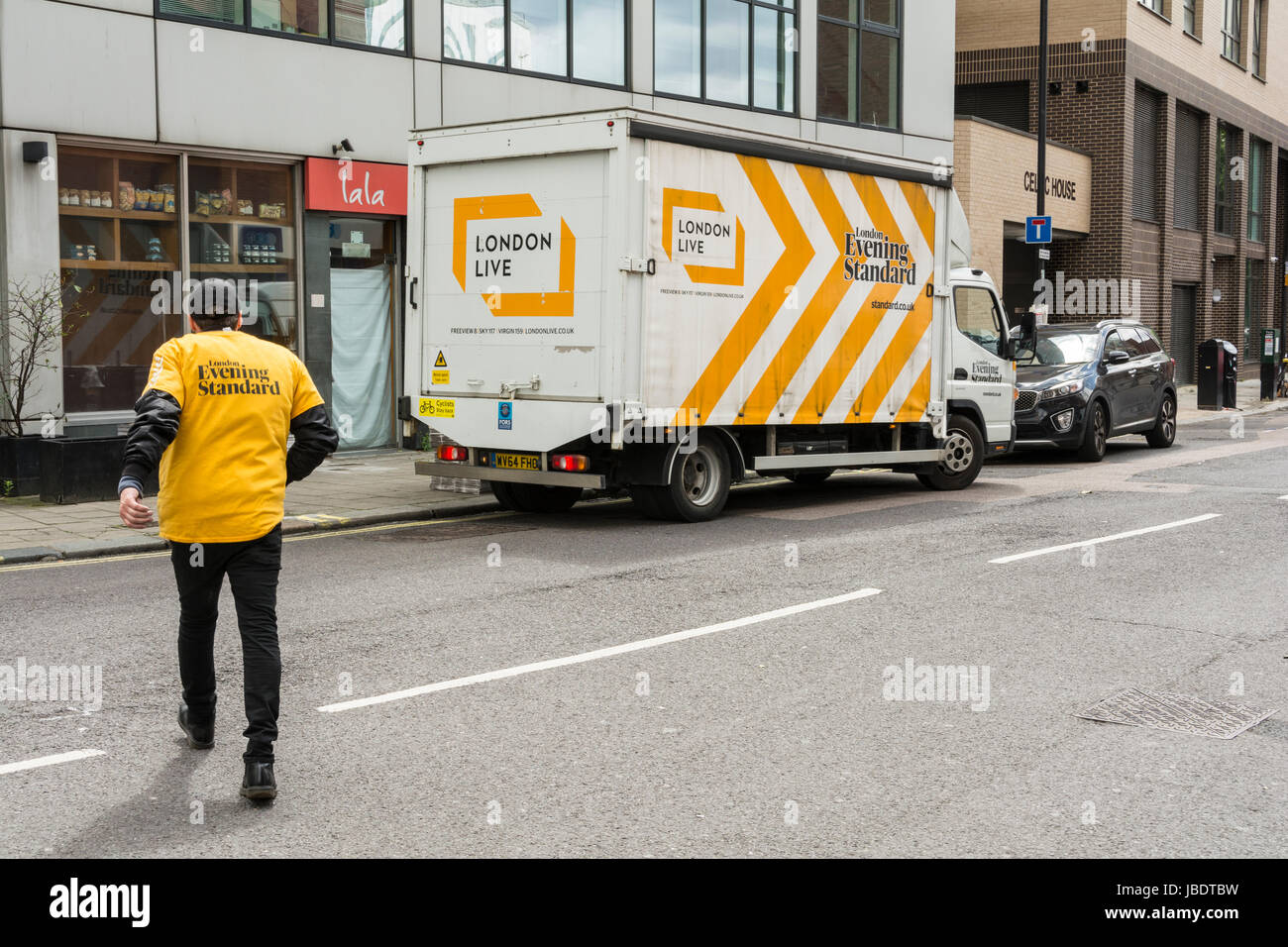 An Evening Standard employee and van in west London Stock Photo - Alamy