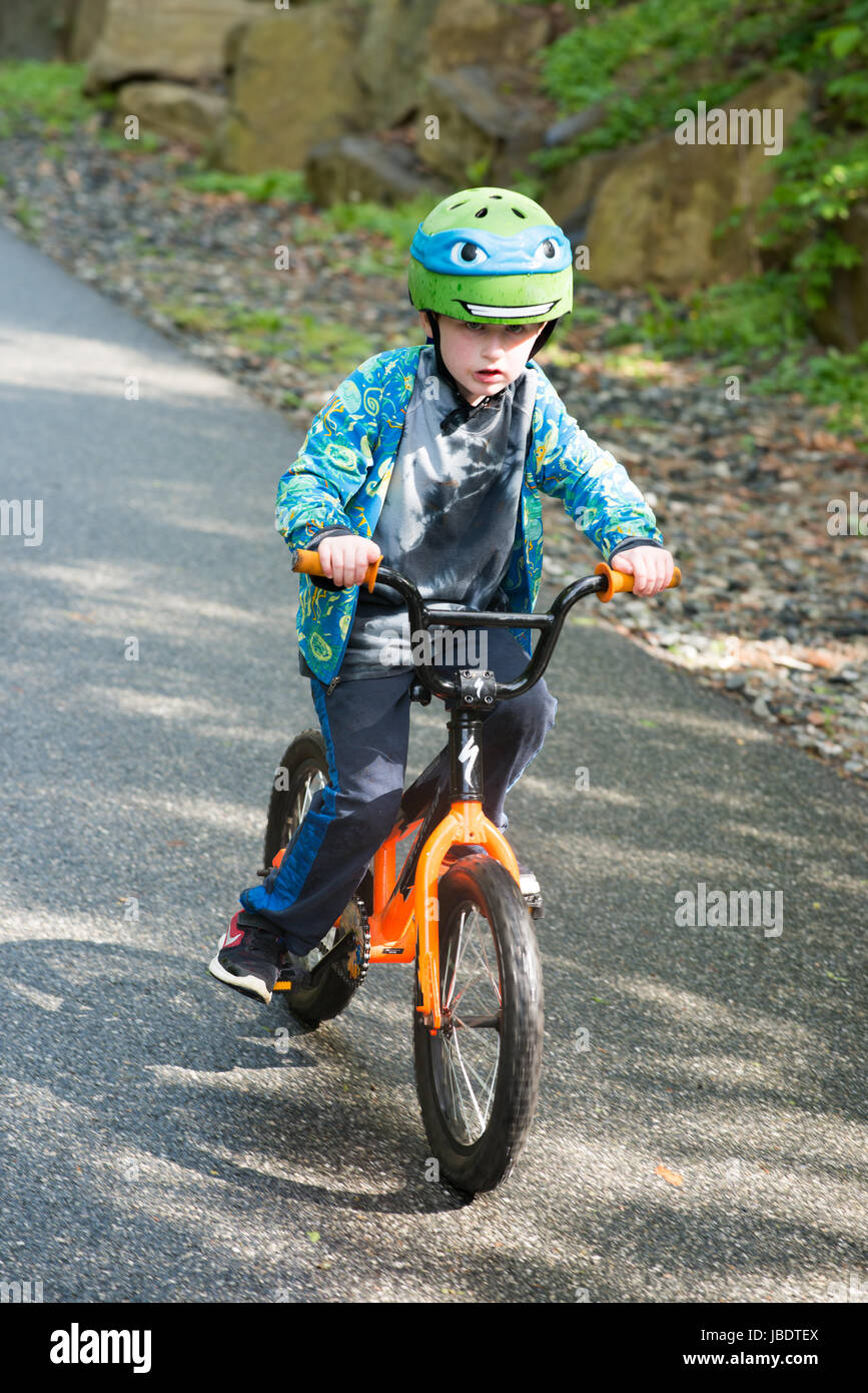 Young Boy Riding Bike on paved trail Stock Photo - Alamy