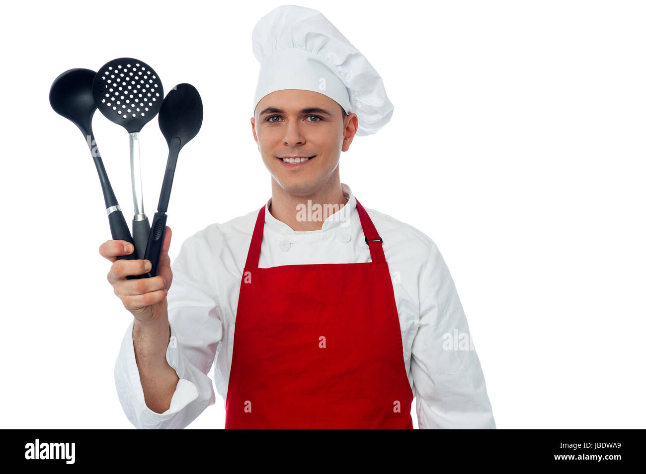 Handsome male chef holding kitchen utensils Stock Photo - Alamy