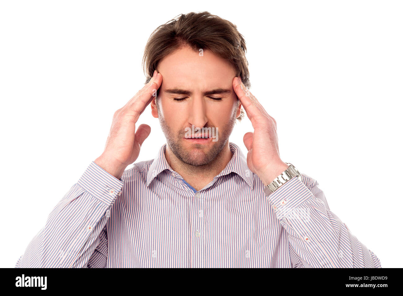 Man suffering from headache wincing Stock Photo - Alamy