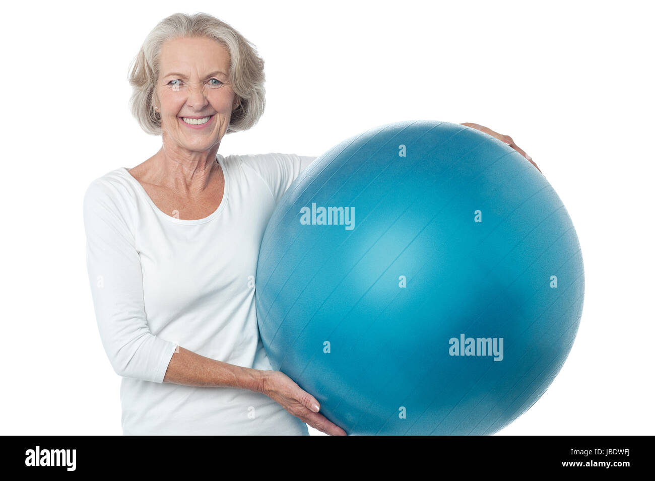 Fit aged woman holding big blue exercise ball Stock Photo - Alamy