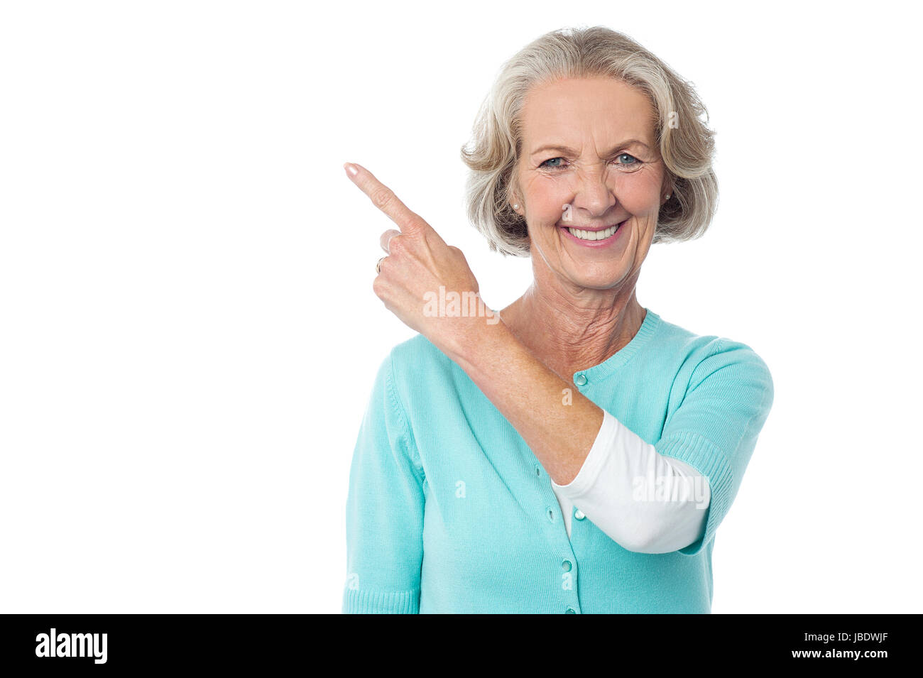 Smiling senior lady pointing towards something Stock Photo - Alamy