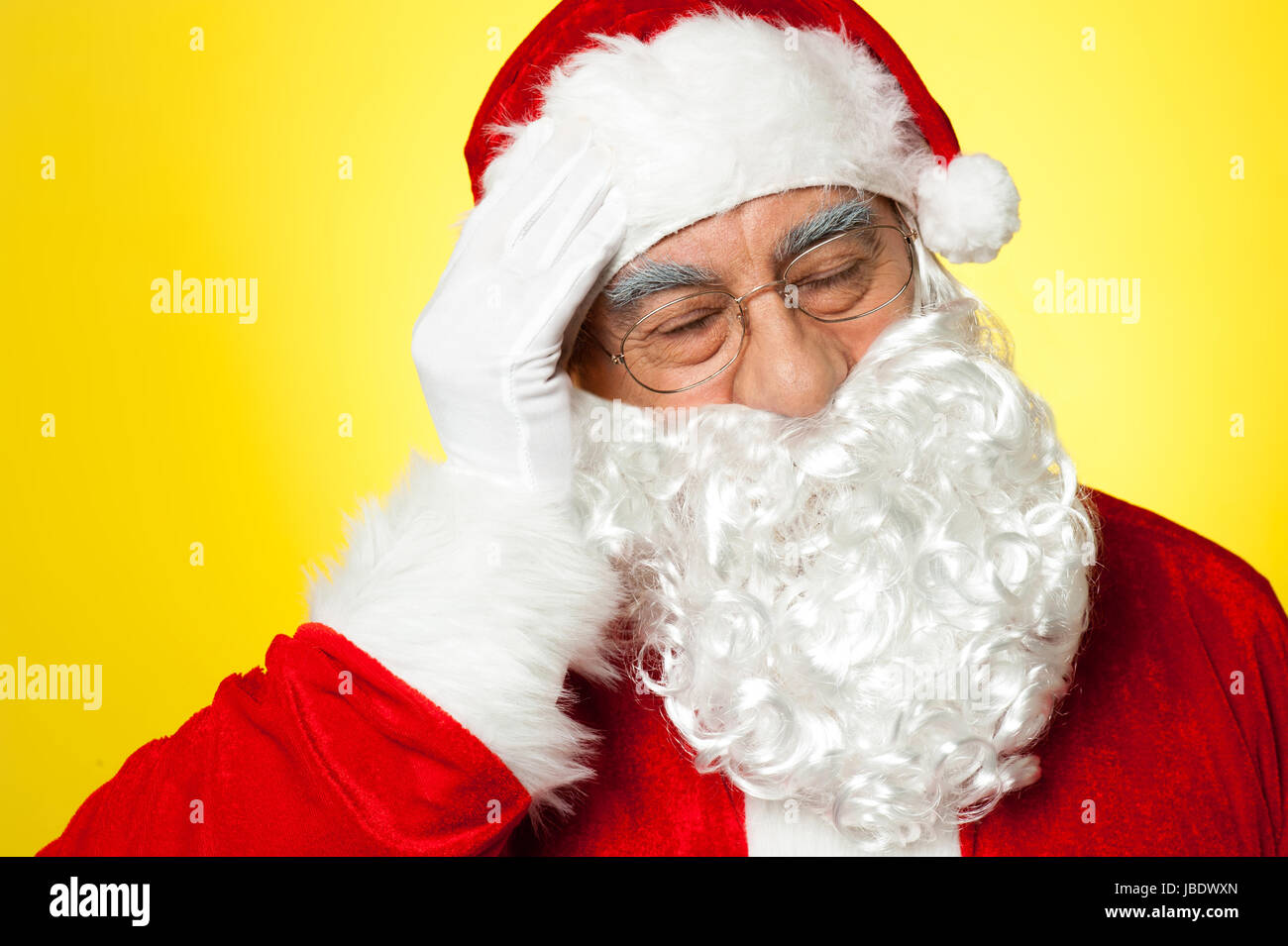 Santa claus suffering from headache Stock Photo - Alamy