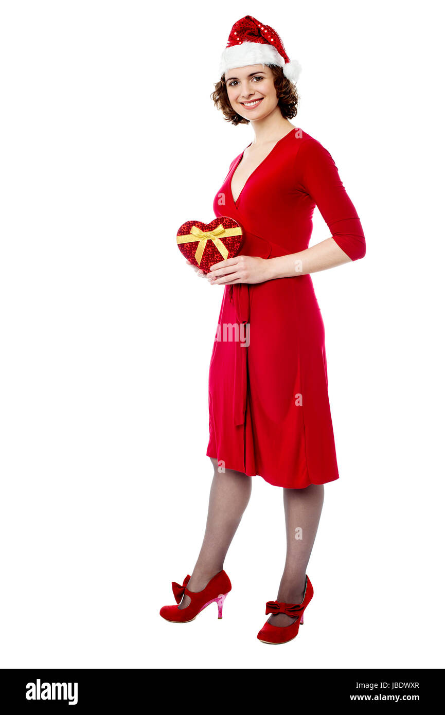 Pretty female santa posing with christmas gift Stock Photo - Alamy