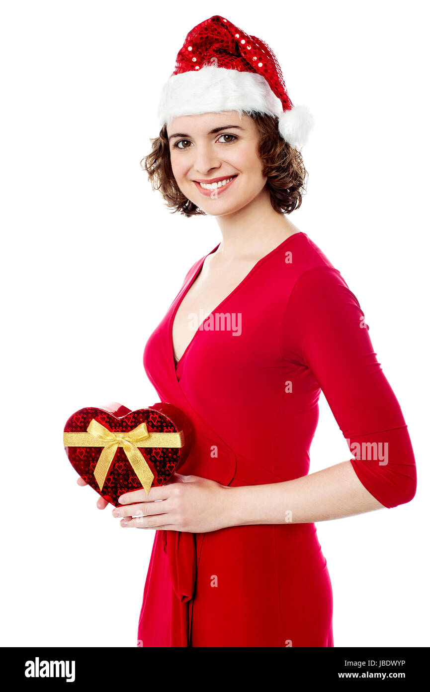 Attractive young santa posing with xmas gift Stock Photo - Alamy