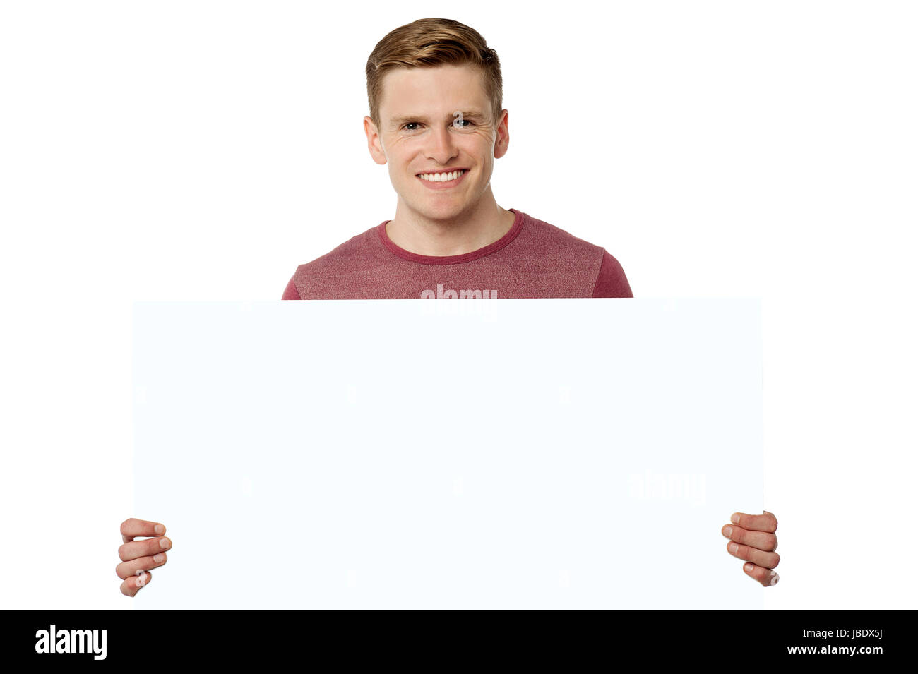 Cheerful young guy holding blank whiteboard Stock Photo - Alamy