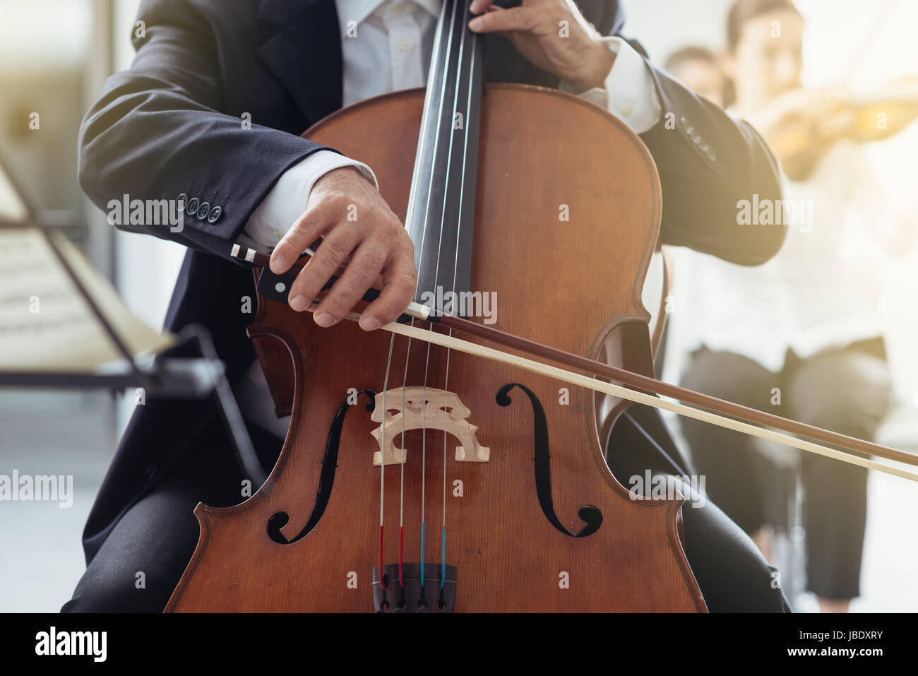 Professional cello player performing with other musicians, classical ...