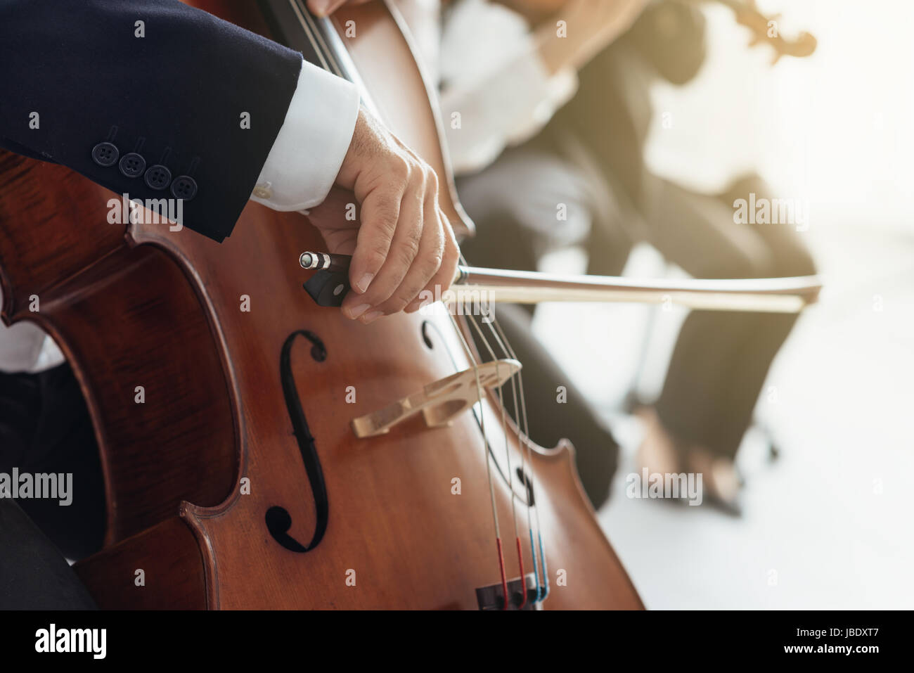 Professional cello player's hands close up, he is performing with ...