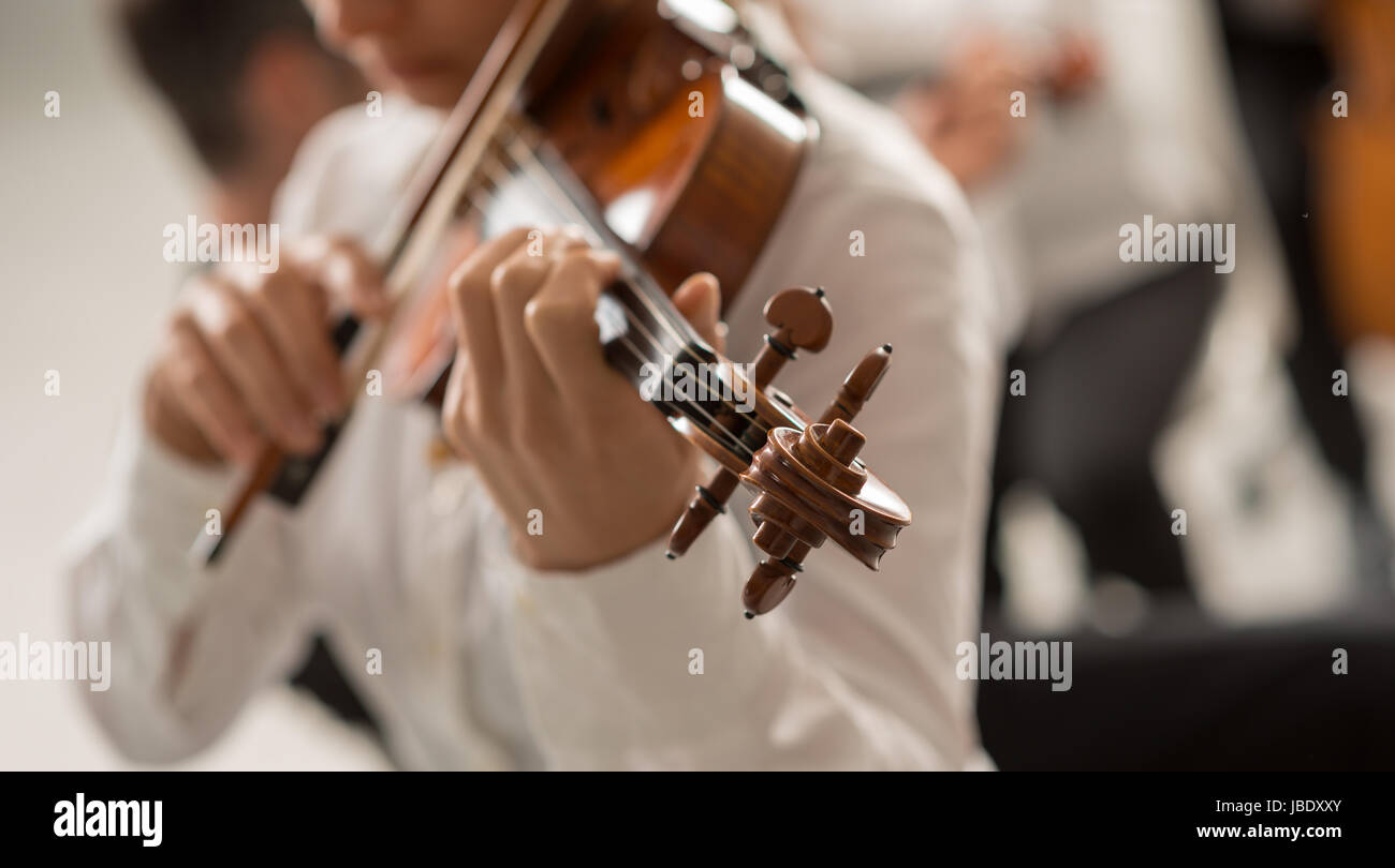 Talented female violinist playing her violin with classical music ...