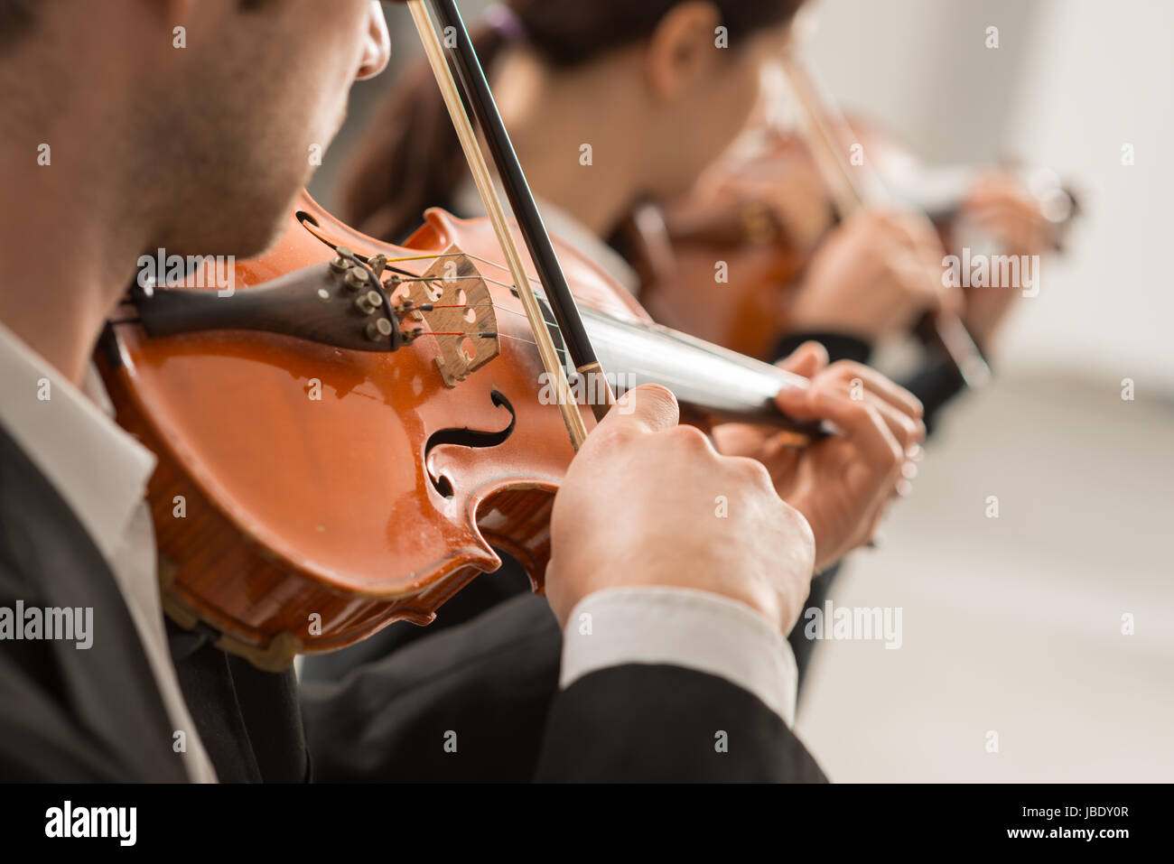 Two violinists performing together hands close up, classical music ...