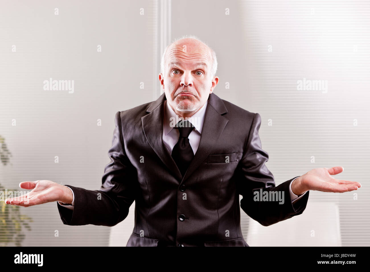 feeble businessman expressing impotence with a typical italian gesture ...