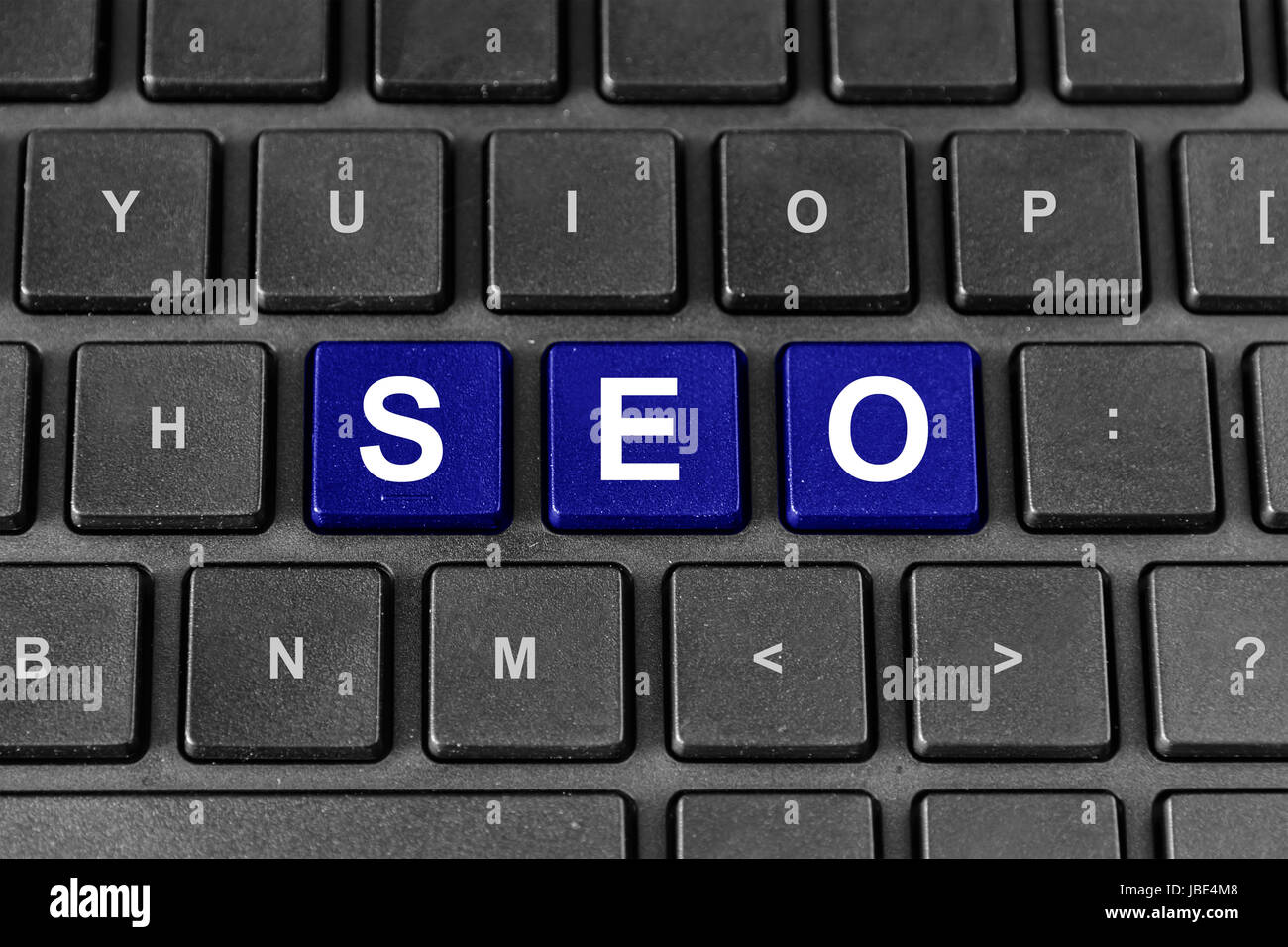 blue SEO or search engine optimization word on keyboard Stock Photo - Alamy