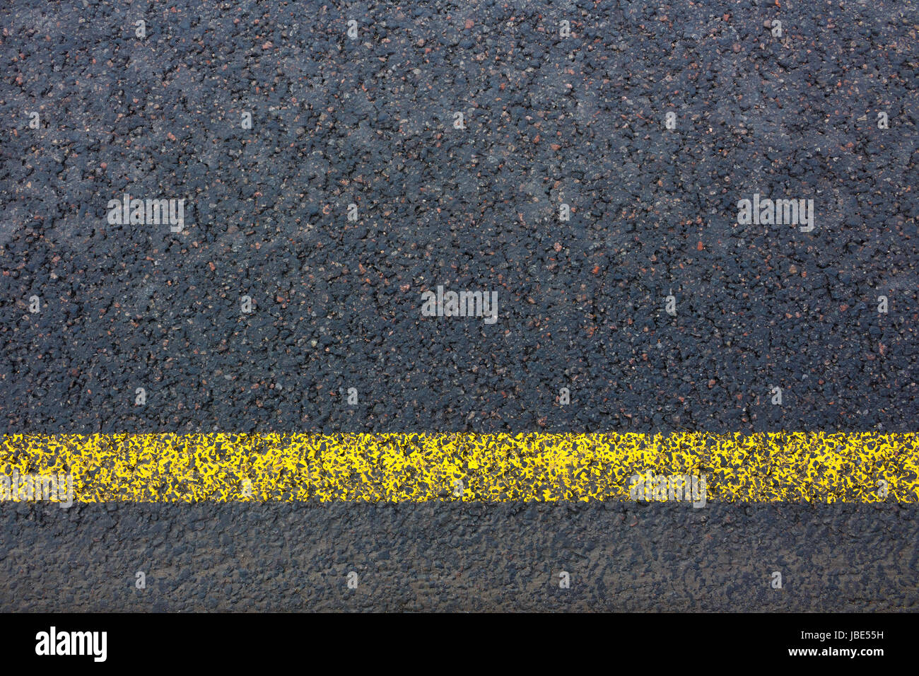 Road marking with yellow lines on dark asphalt close up Stock Photo - Alamy