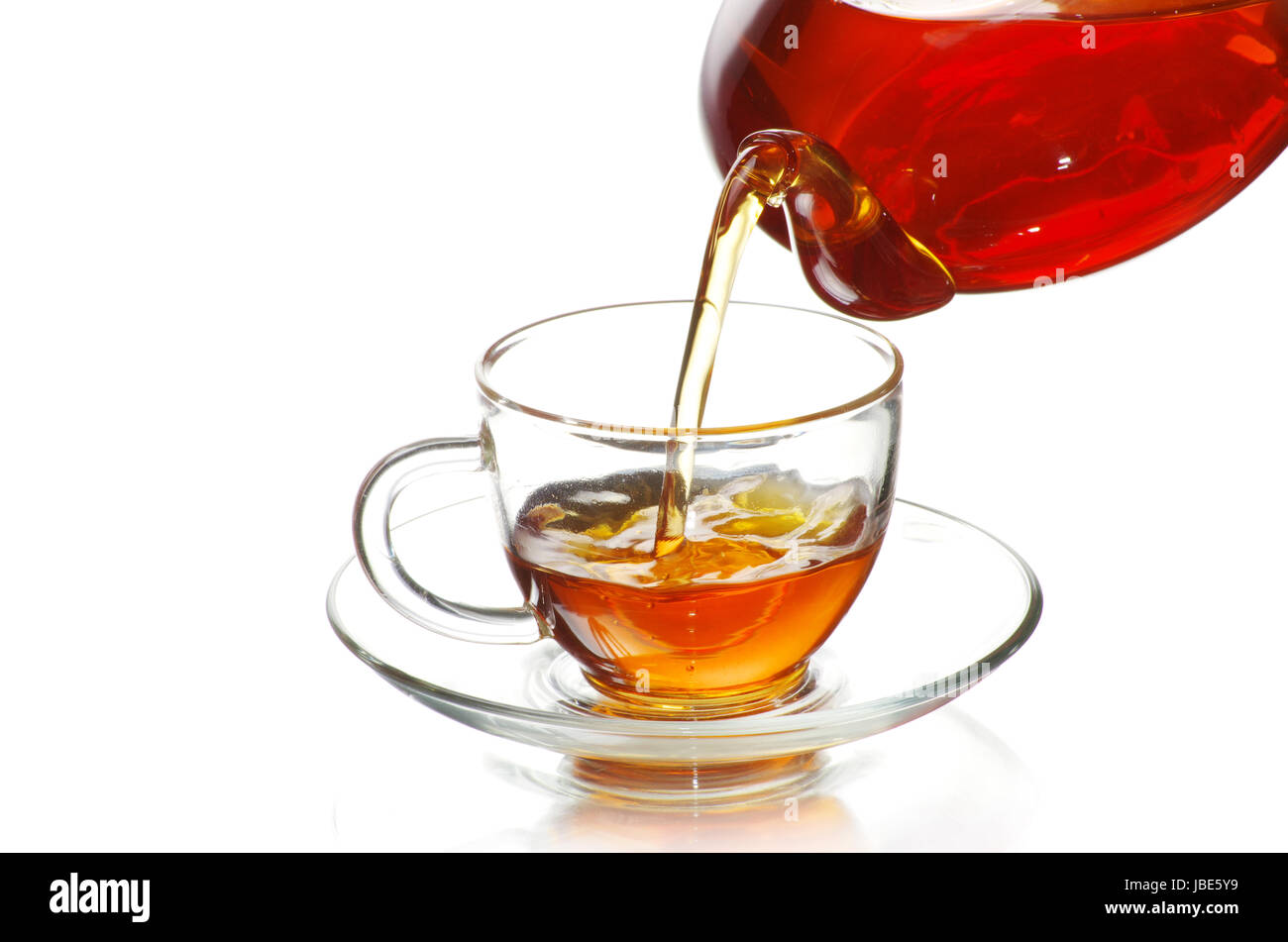 Tea being poured into glass tea cup Stock Photo - Alamy