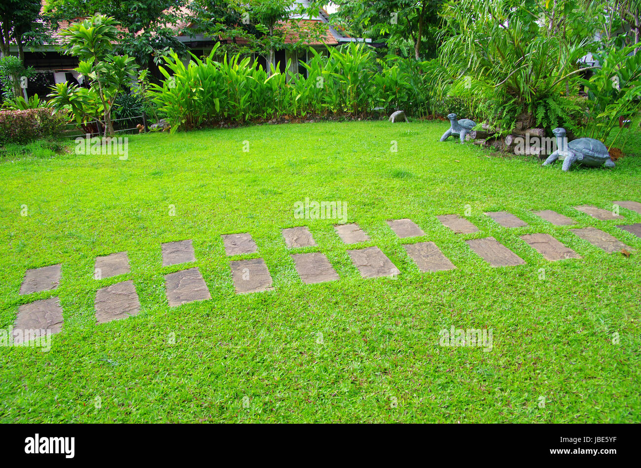 Garden stone path with grass Stock Photo - Alamy