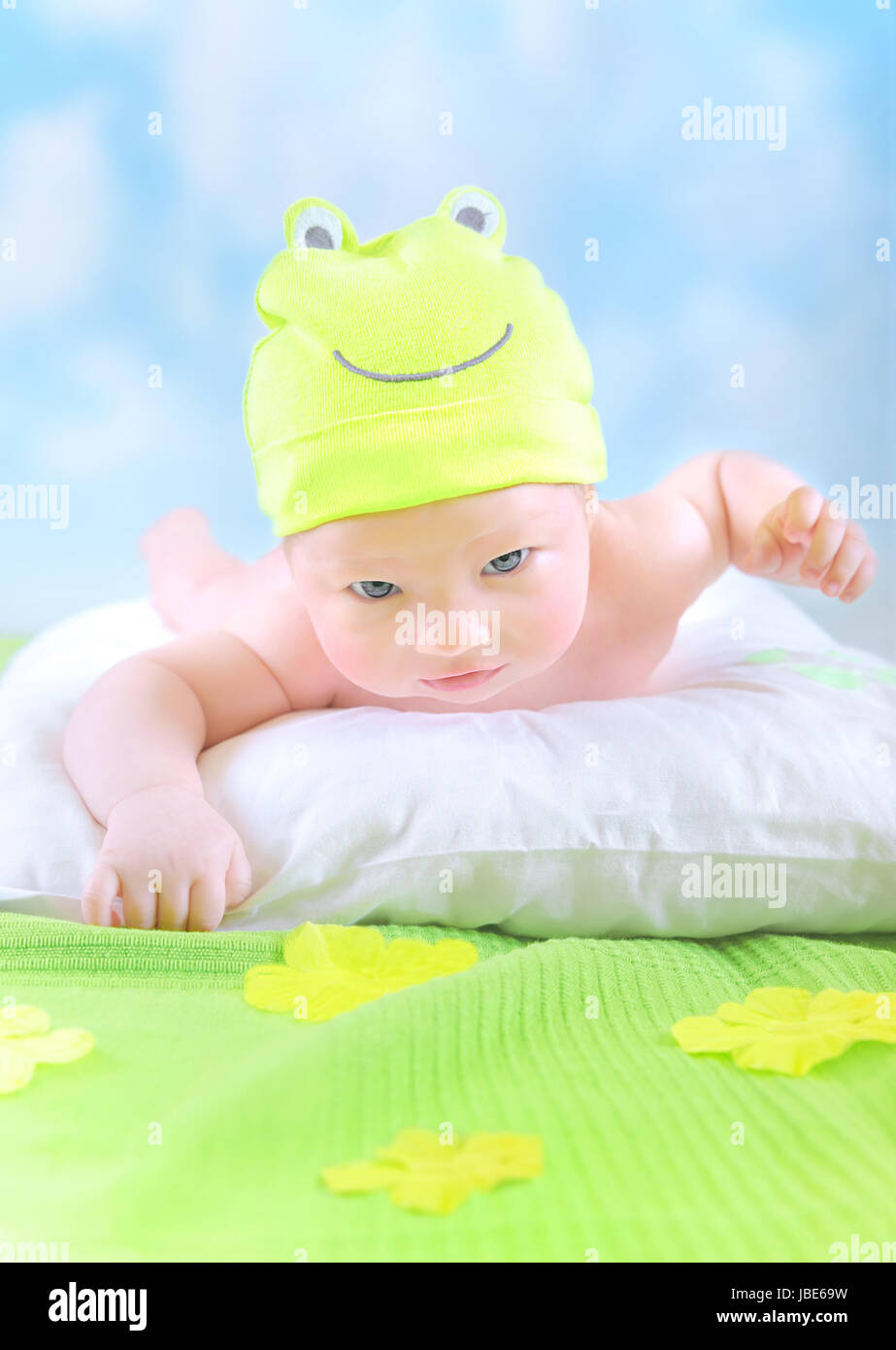 Closeup portrait of cute little baby wearing funny frog costume and ...