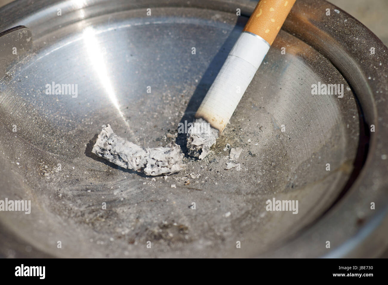 Cigarette in ashtray Stock Photo - Alamy