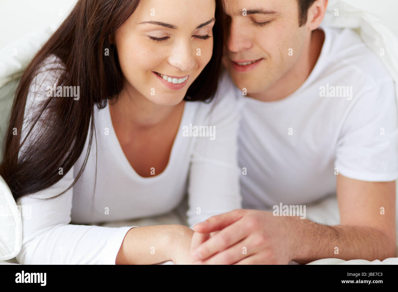 Amorous couple lying in bed hi-res stock photography and images - Alamy