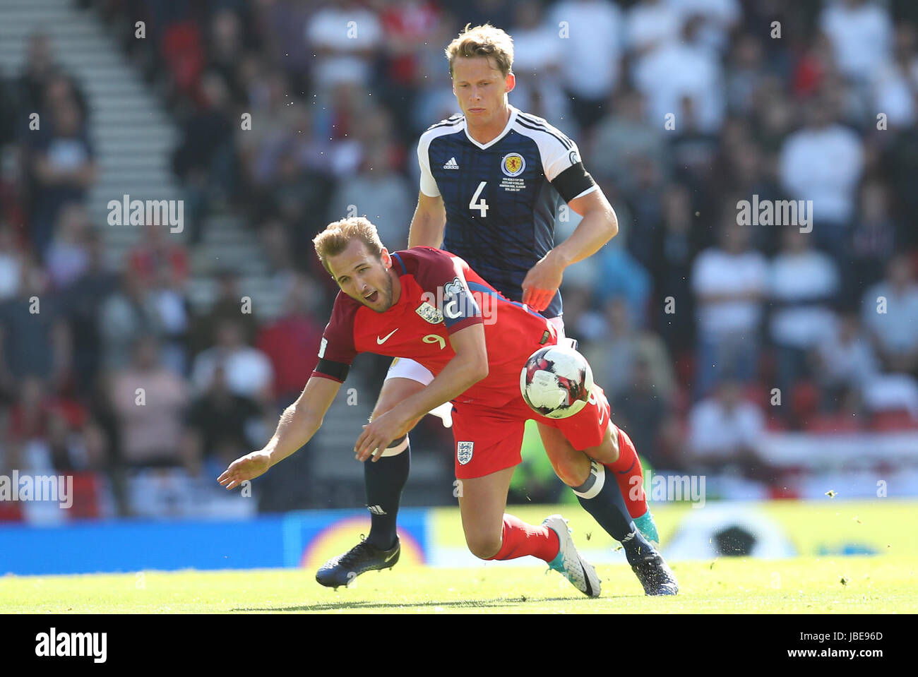 England's Harry Kane (left) is fouled by Scotland's Christophe Berra ...
