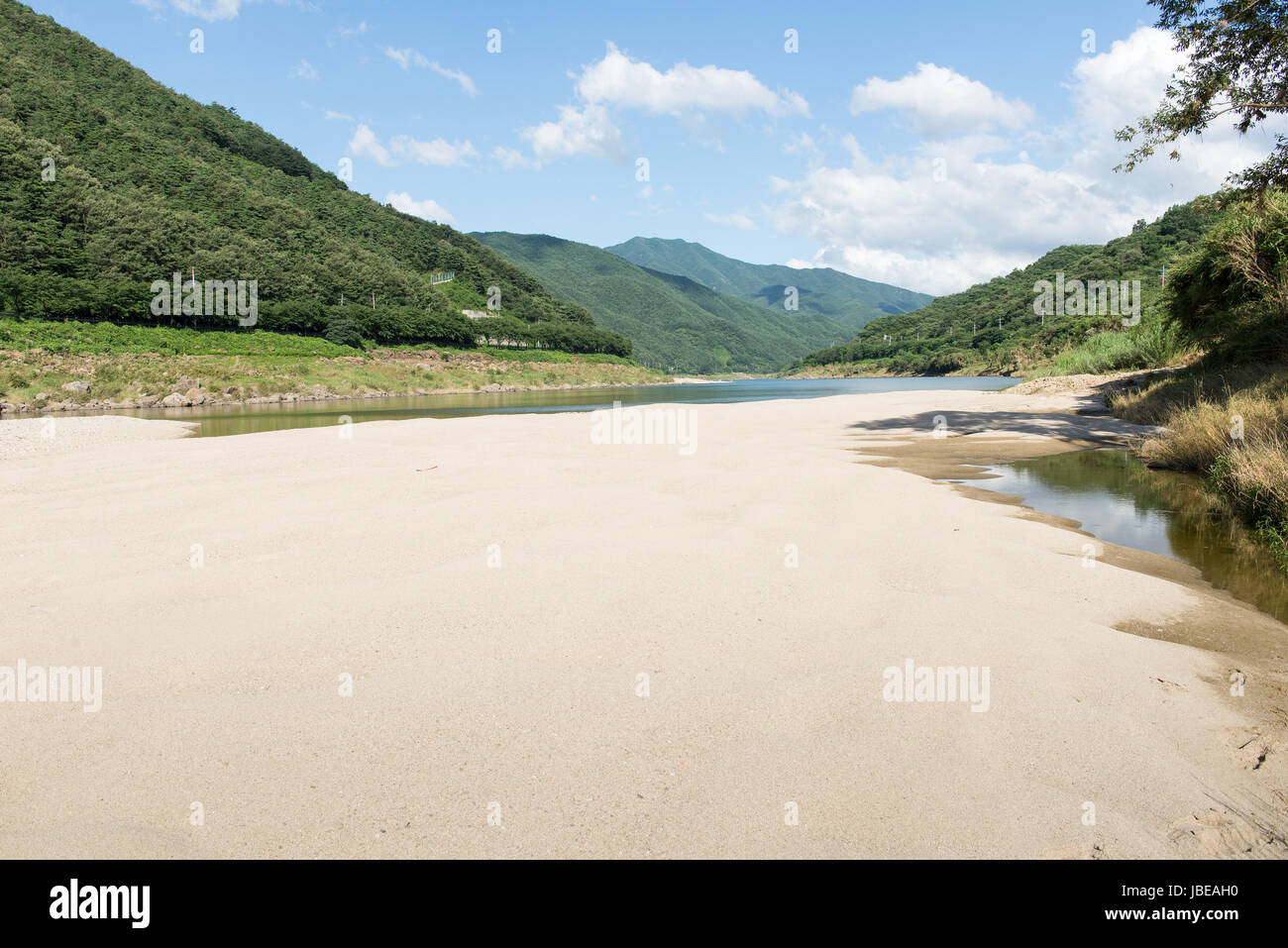 River bed landscape in South Korea with sandbank and green mountains ...