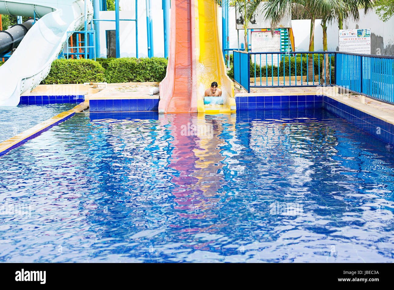Adult man sliding down slide hi-res stock photography and images - Alamy