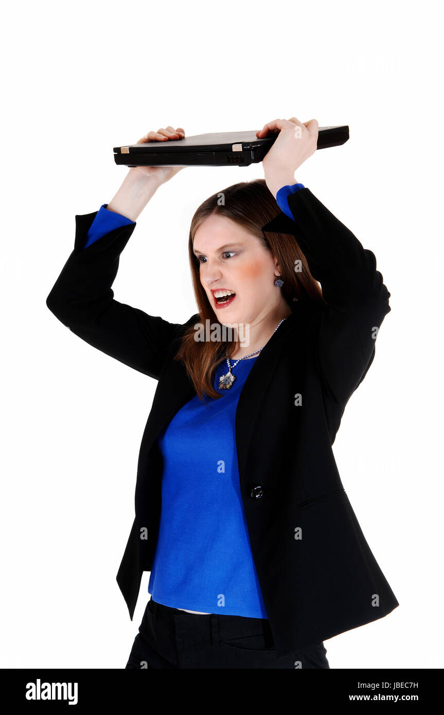 A young business woman in a black suit throwing her laptop very angry ...