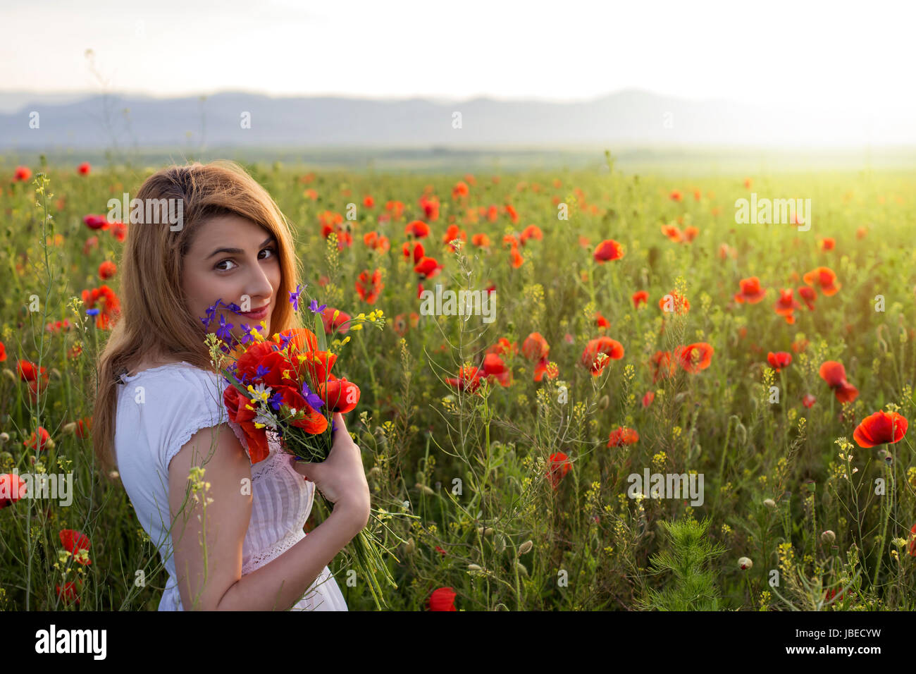 Woman in poppy field hi-res stock photography and images - Alamy