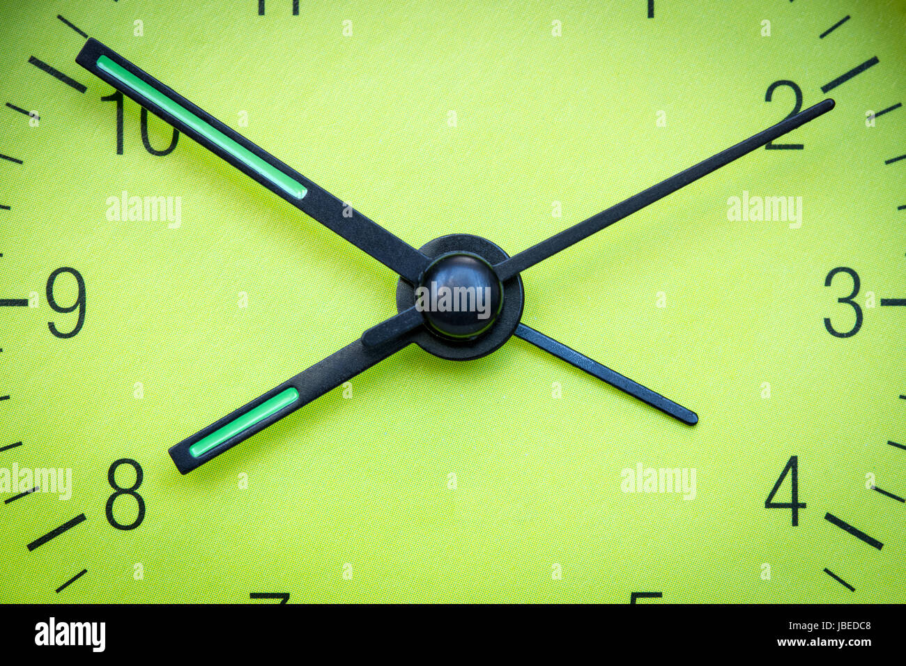 Closeup of hands on green clock face Stock Photo - Alamy