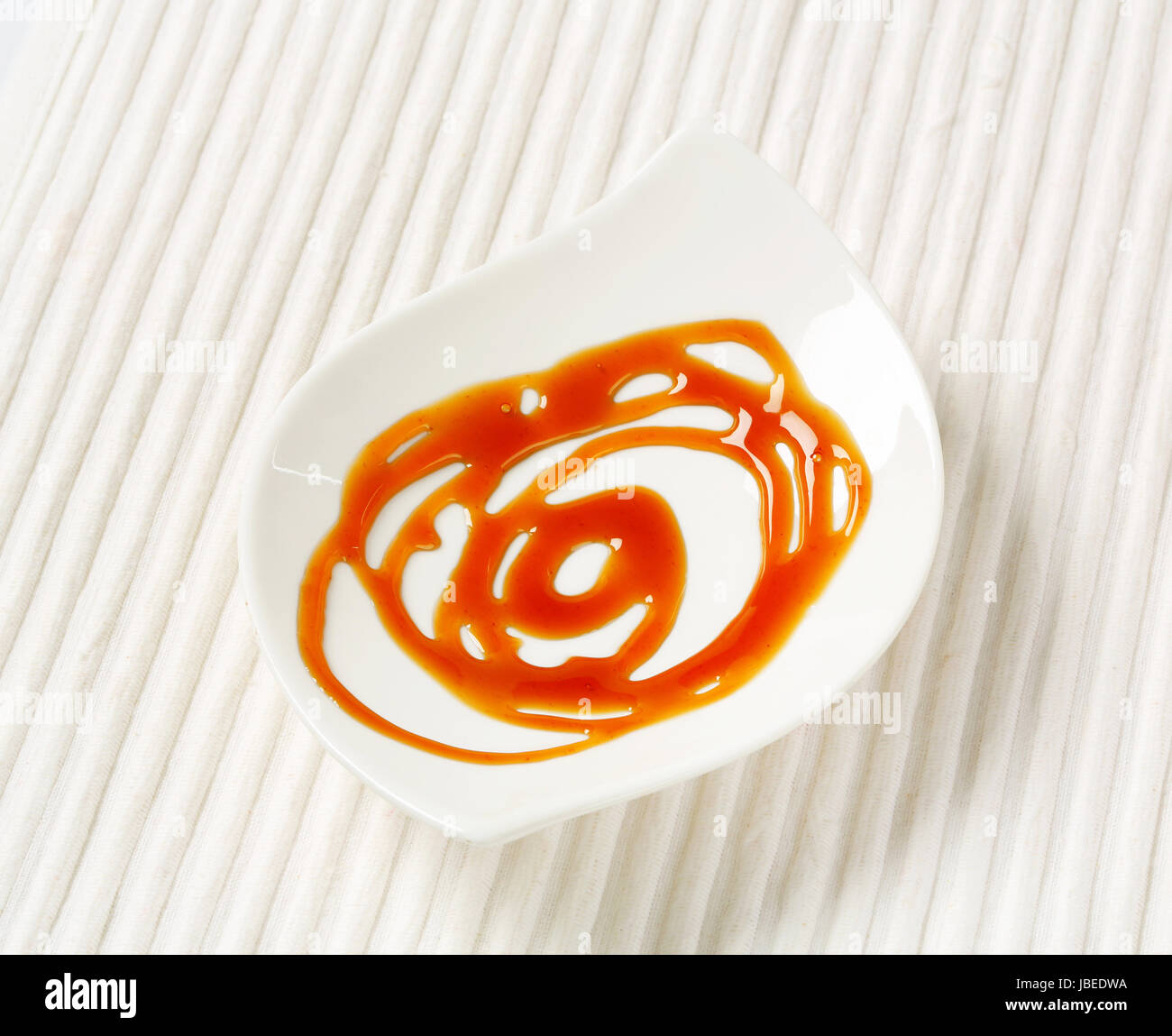 Caramel drizzle sauce on plate Stock Photo - Alamy
