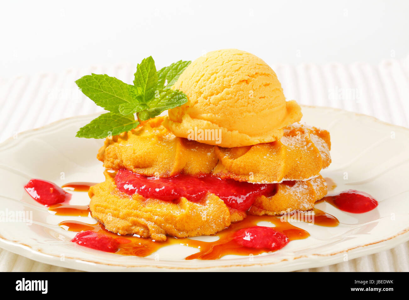 Spritz cookies with raspberry sauce and ice cream Stock Photo - Alamy