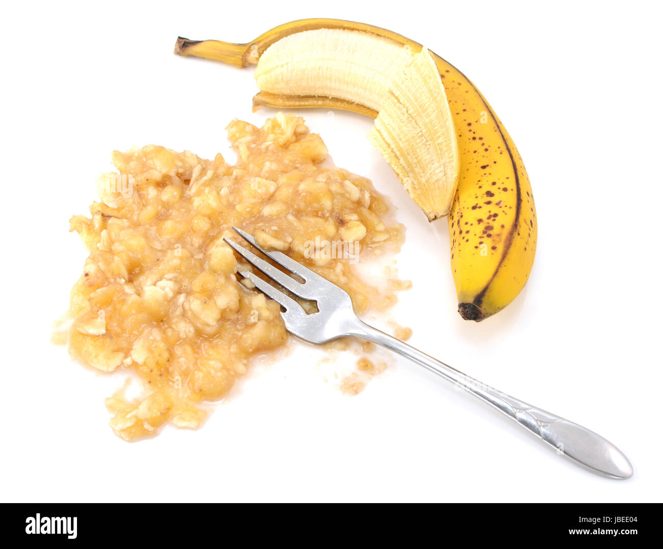 Half-peeled ripe banana with mashed fruit, isolated on a white ...