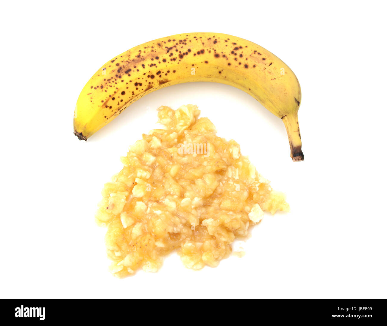 Spotty ripe whole banana with mashed fruit, isolated on a white ...