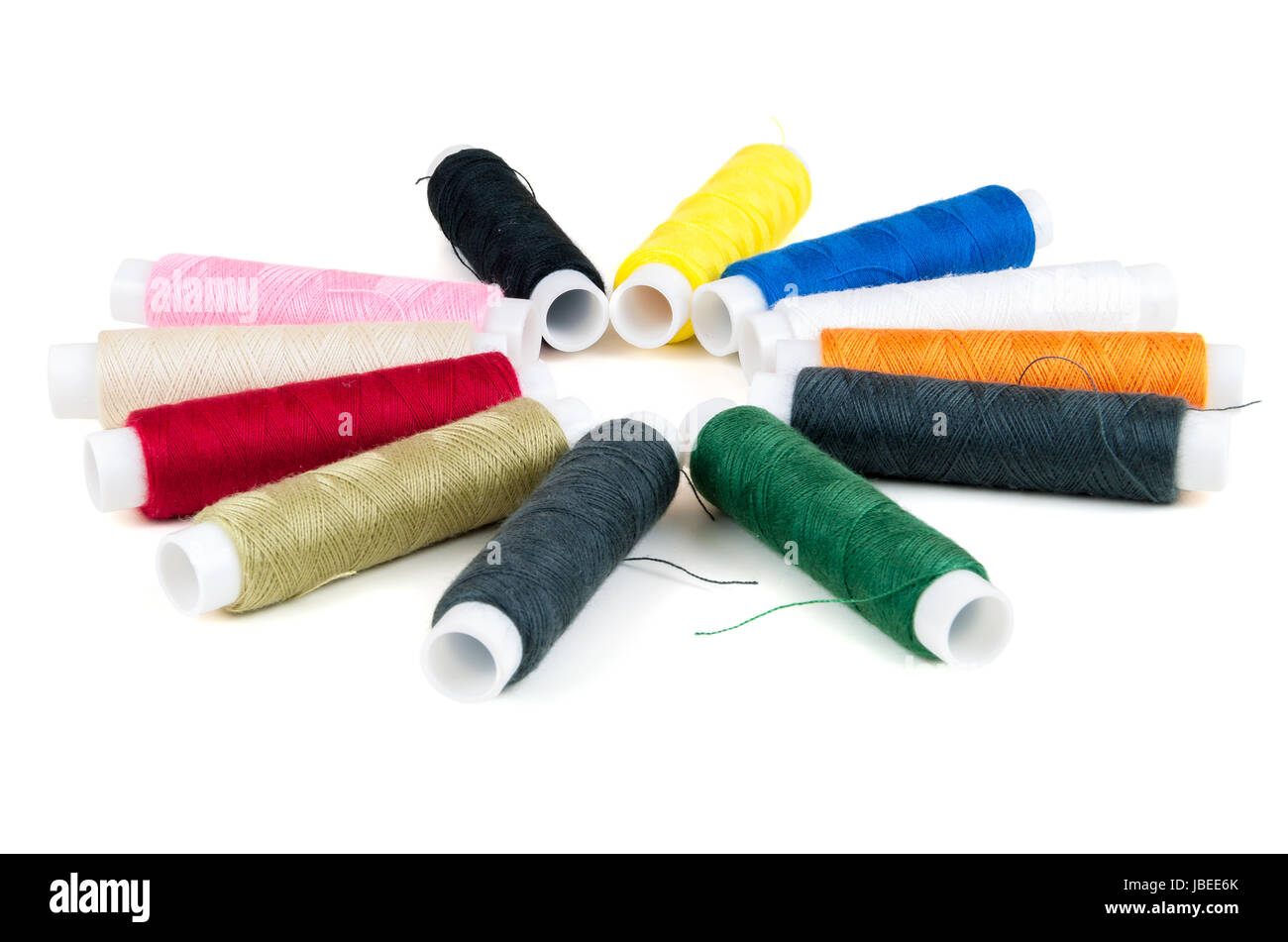 Colored spools of threads isolated on white background Stock Photo - Alamy