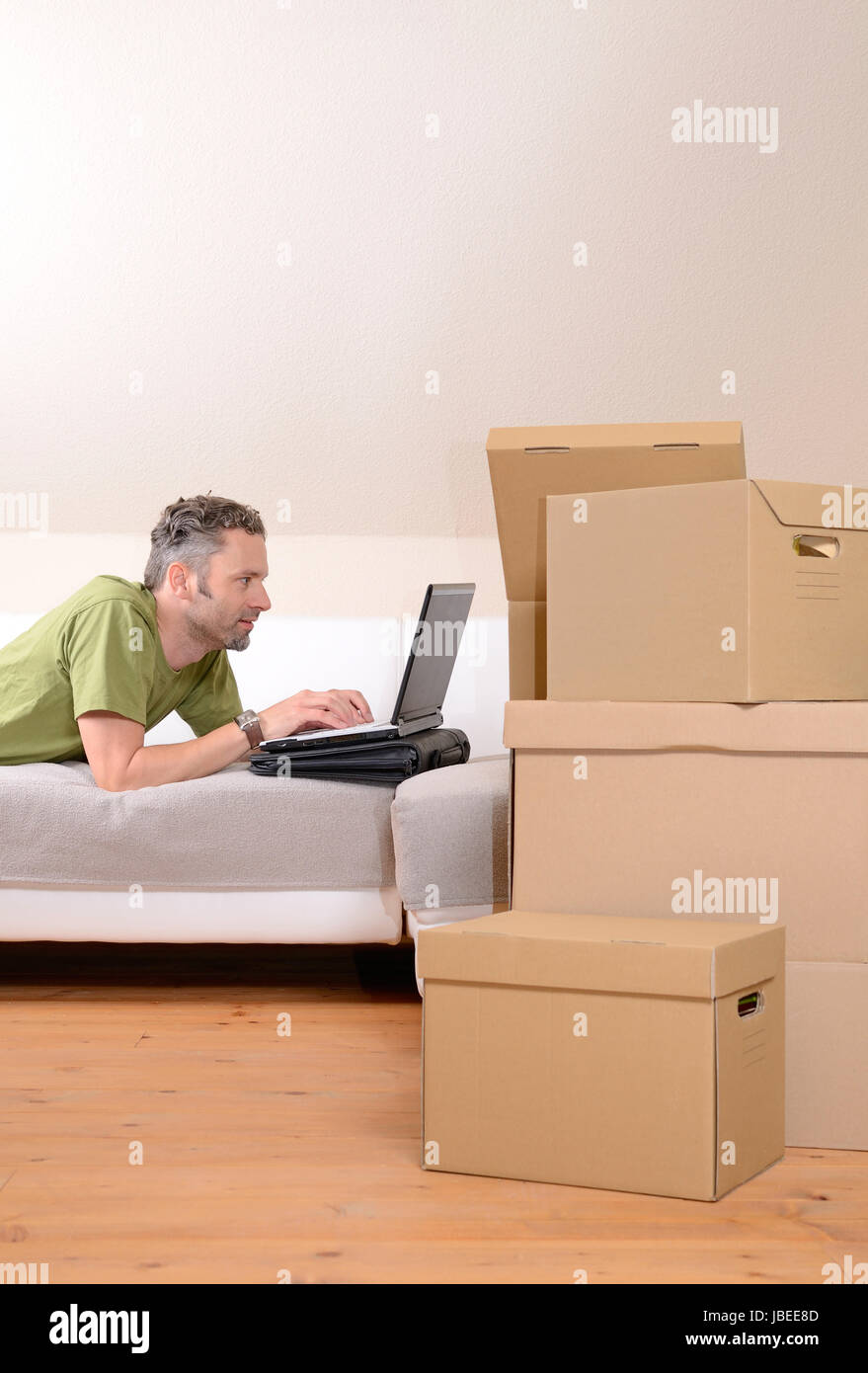 Happy man moving in new home Stock Photo - Alamy