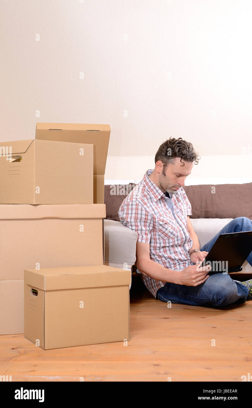 Happy man moving in new home Stock Photo - Alamy