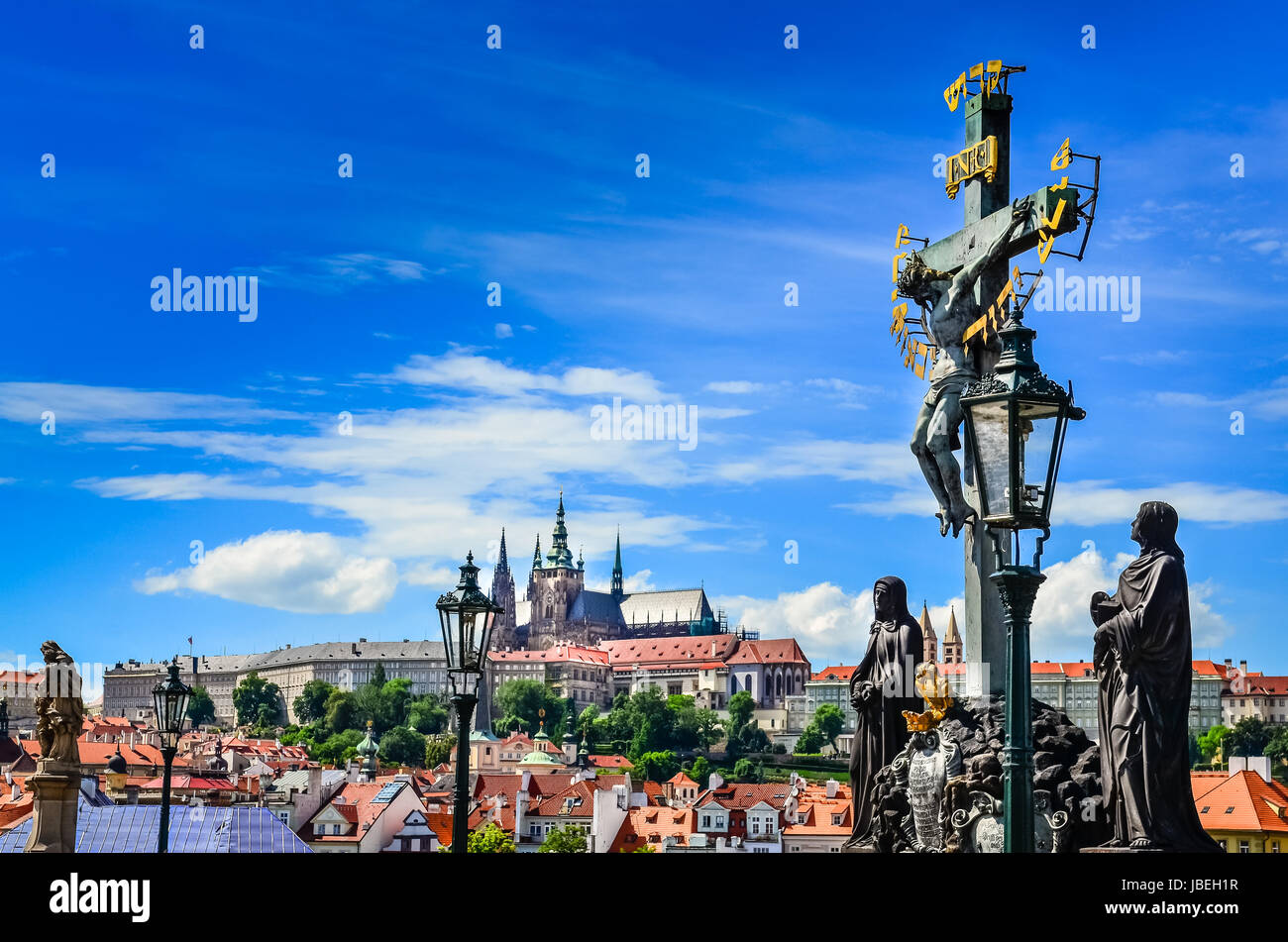 View of Prague castle from Charles Bridge with cross and statues, Czech ...