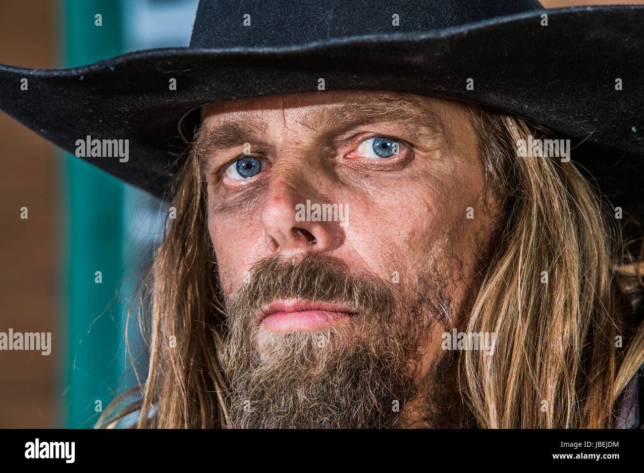 Close-up of a gruff looking old west bandit Stock Photo - Alamy