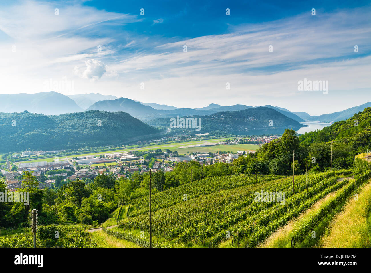 Agno, Switzerland. View of Agno, Lake Lugano, Lugano Airport, vineyards ...