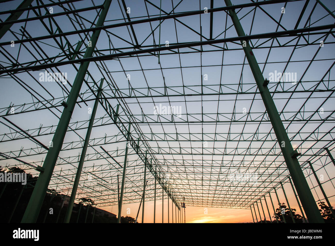 Steel frame warehouse building structure being put together piece by ...
