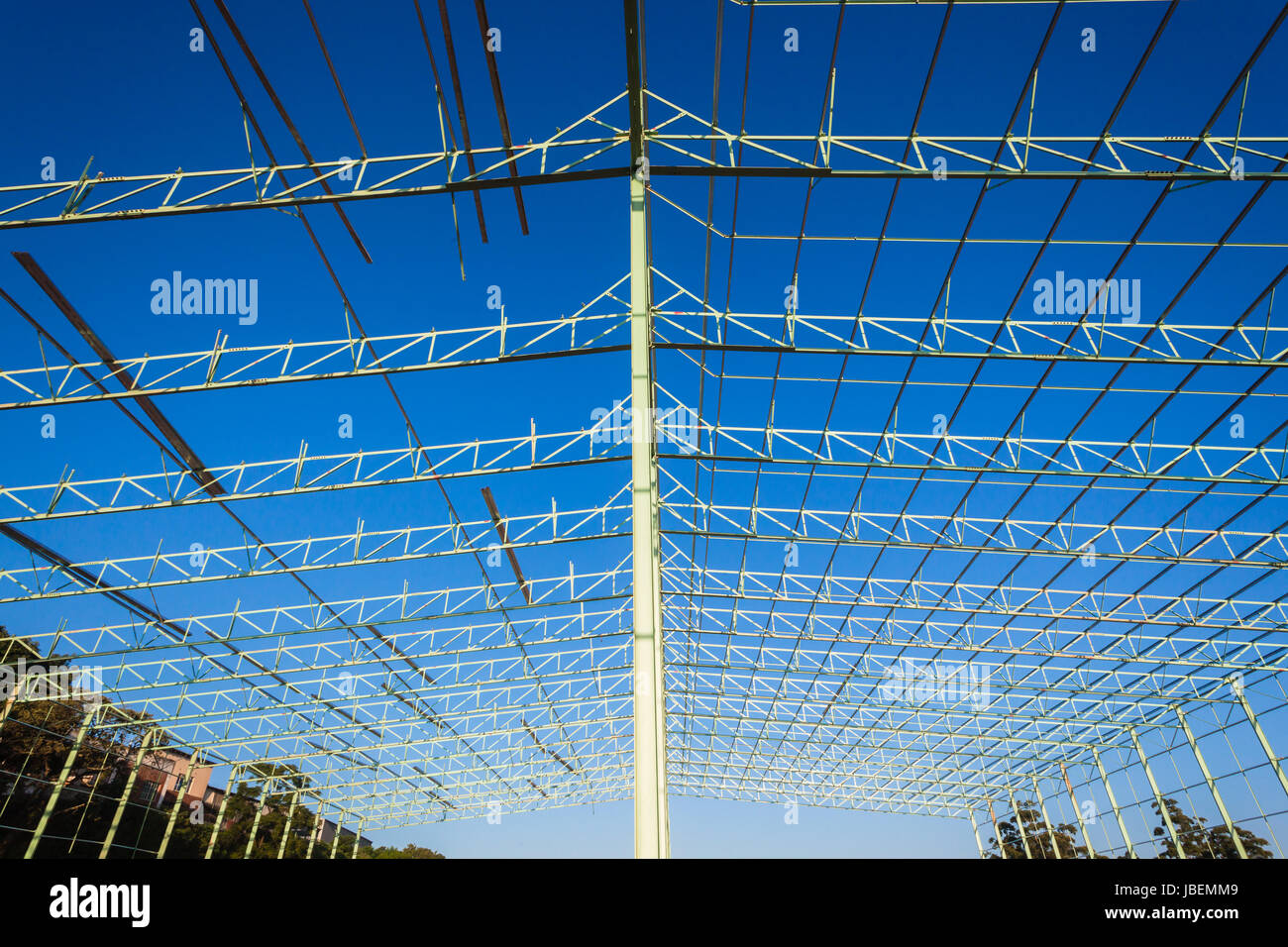 Steel frame warehouse building structure being put together piece by ...