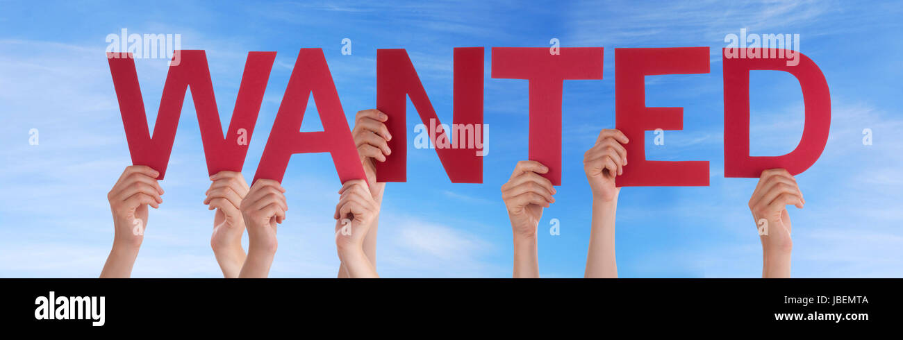 Many People Holding the Word Wanted in the Sky Stock Photo - Alamy