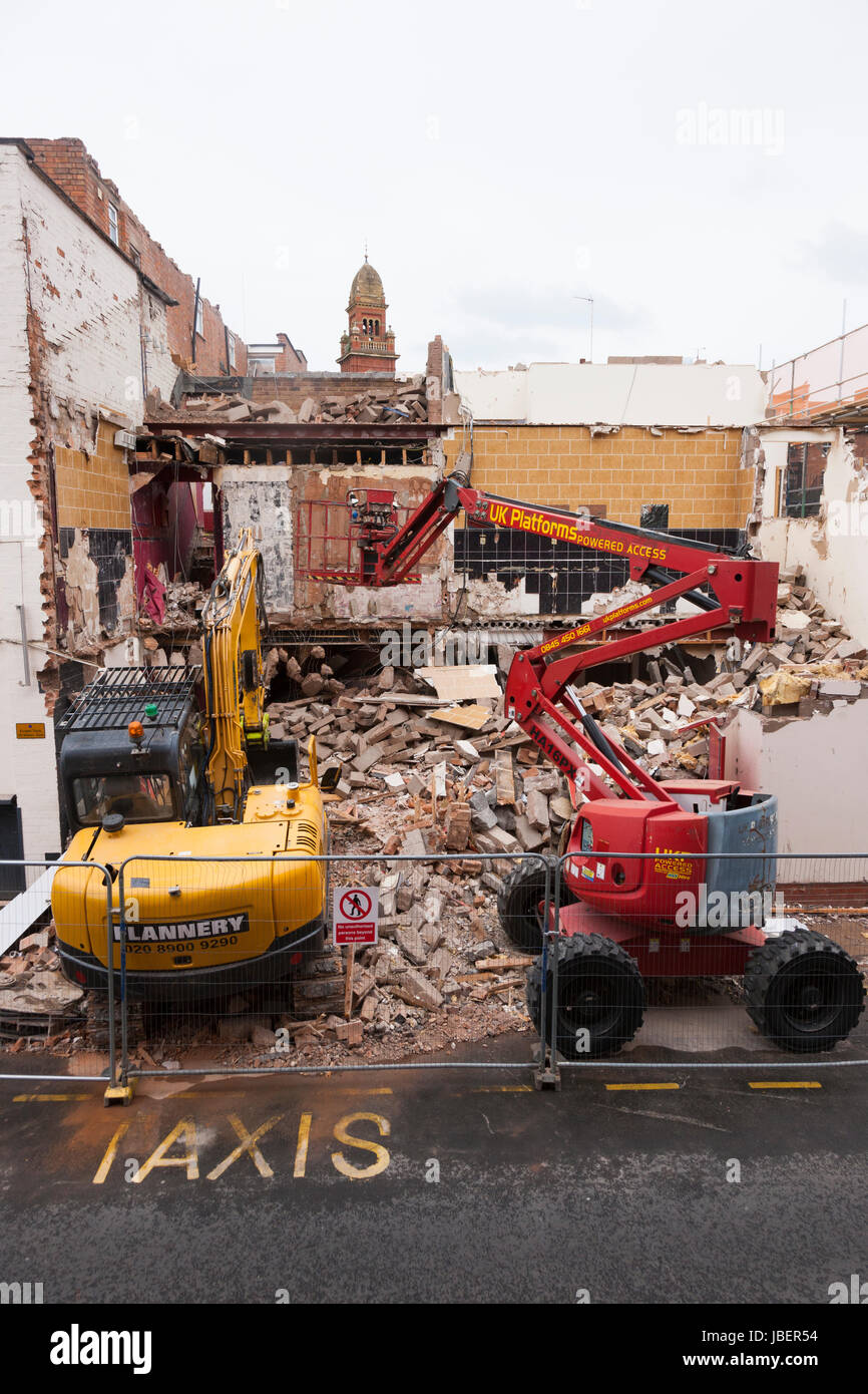 Demolition site with tracked digger, crane heavy hydraulic equipment in ...