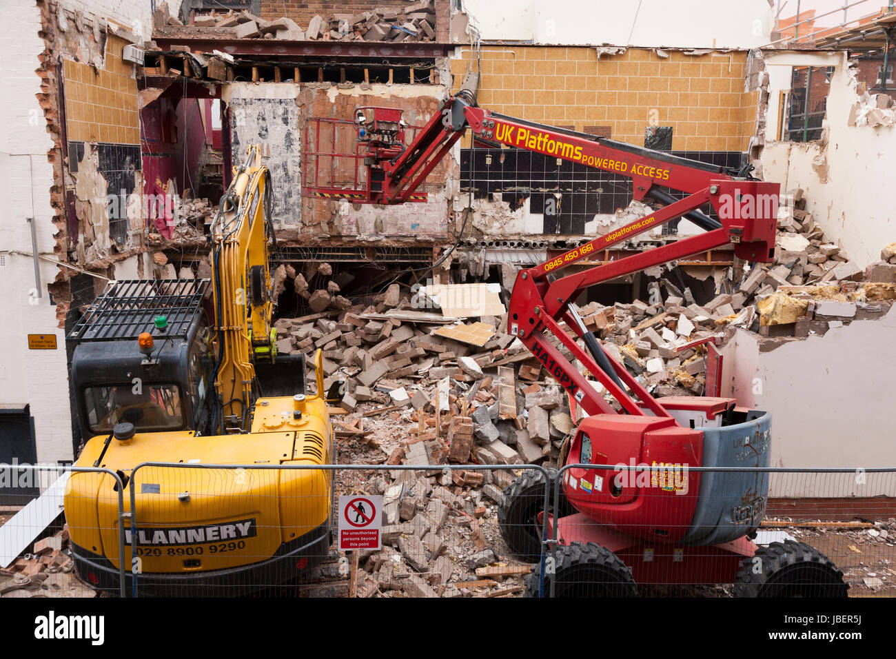 Demolition site with tracked digger, crane heavy hydraulic equipment in ...
