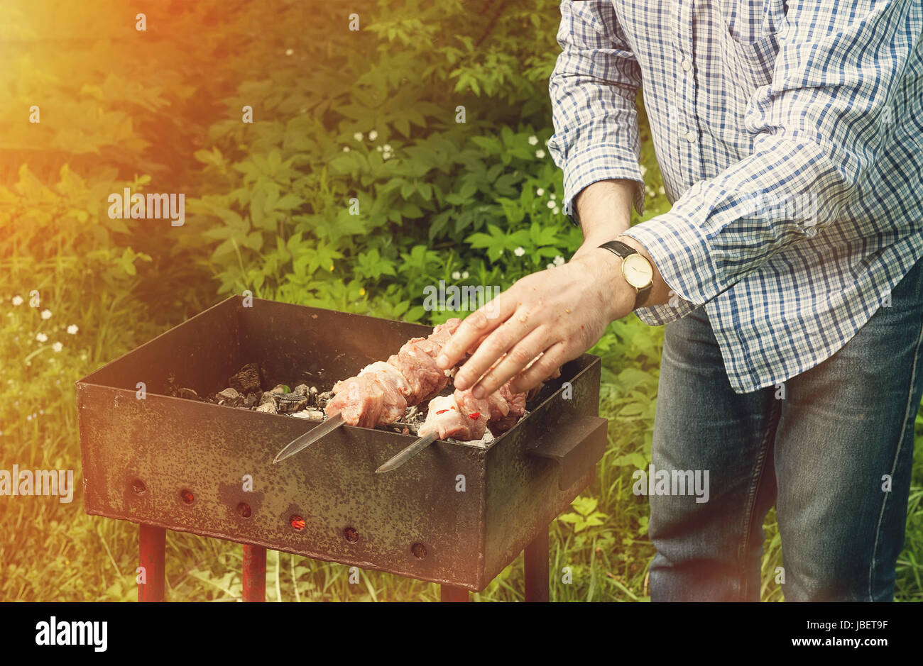 Delicious, juicy barbecue, roasted on a spit over an open fire. The ...