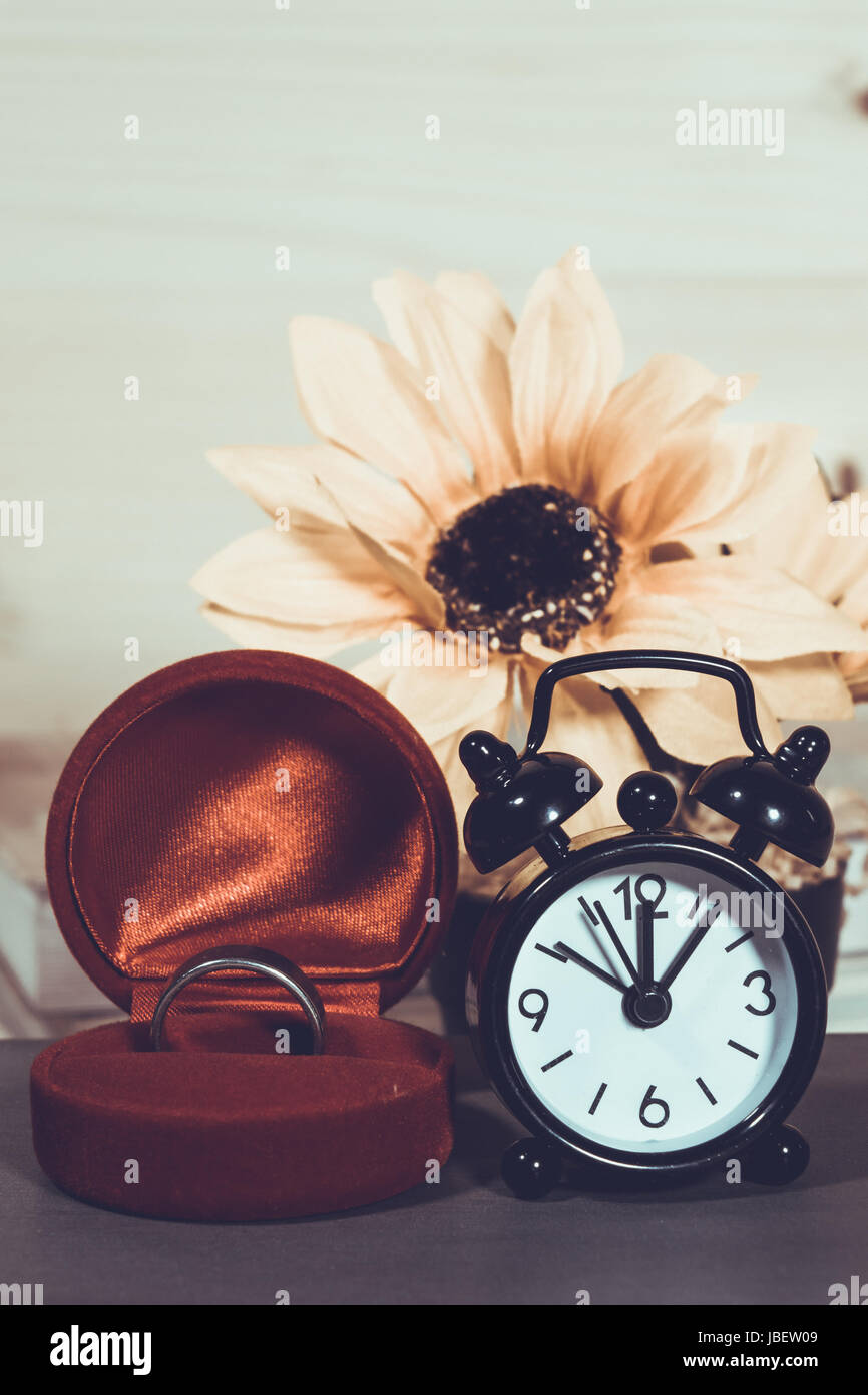 Wedding ring, alarm clock Tell time in life Stock Photo - Alamy