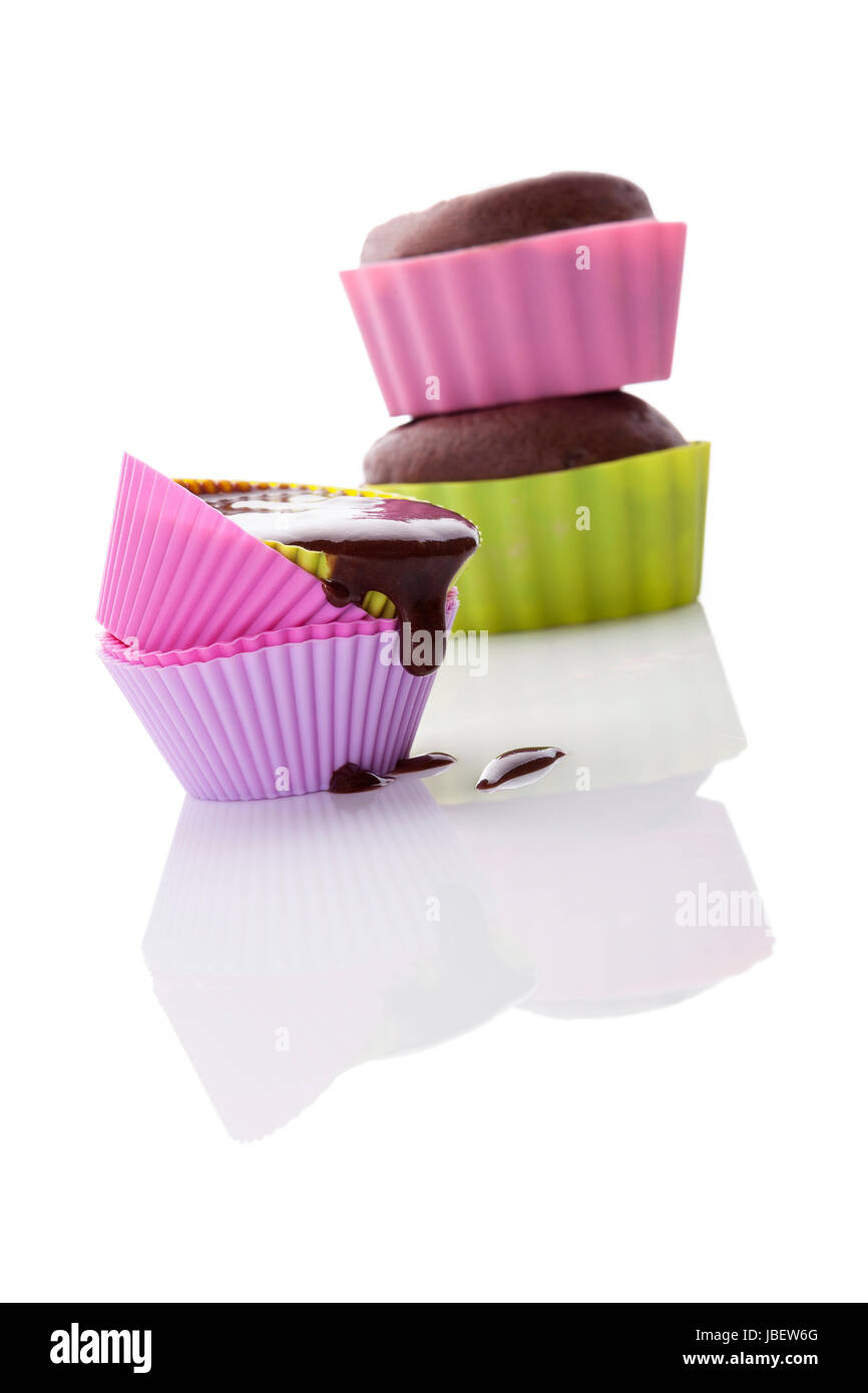 Cupcake mixture dropping from baking form isolated on white background ...